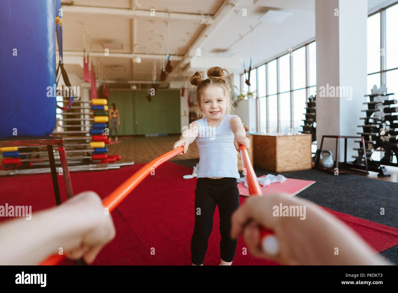Little girl and mom doing exercises with sticks Stock Photo - Alamy