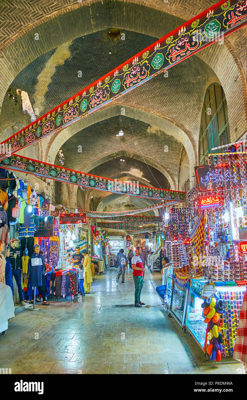 KERMAN, IRAN - OCTOBER 15, 2017: The brightly illuminated narrow alley ...