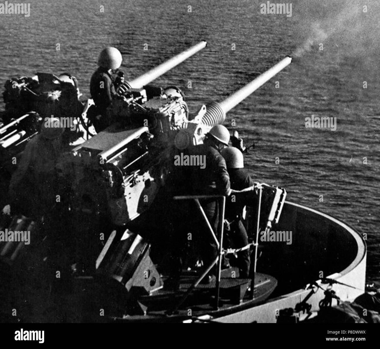 76 mm guns firing on USS Durham (LKA-114) 1970 Stock Photo - Alamy