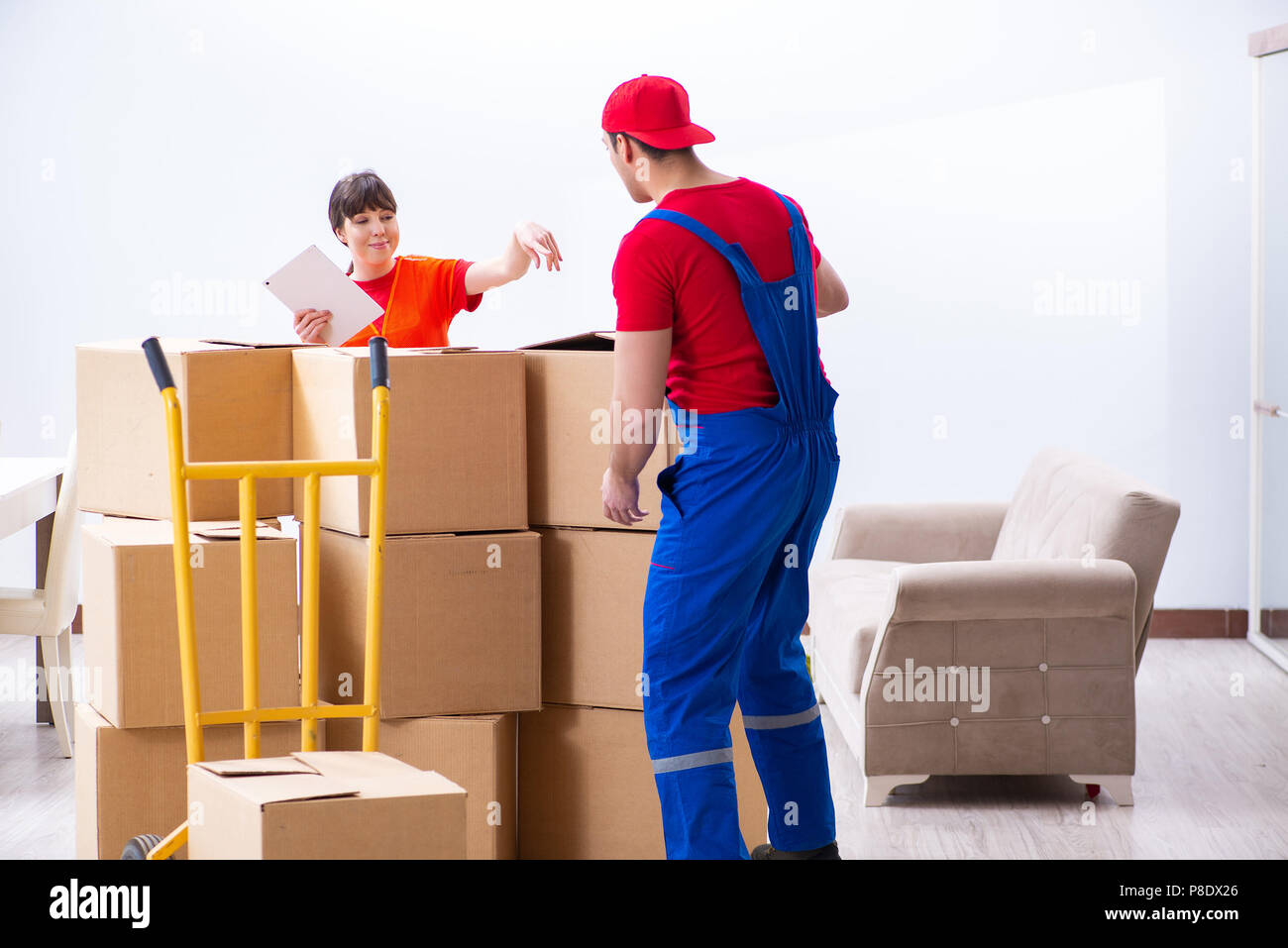 Professional movers doing home relocation Stock Photo - Alamy