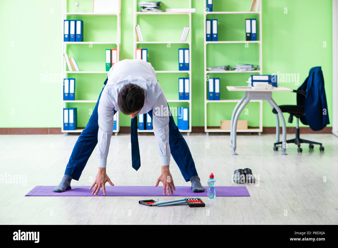 Employee doing exercises during break at work Stock Photo - Alamy