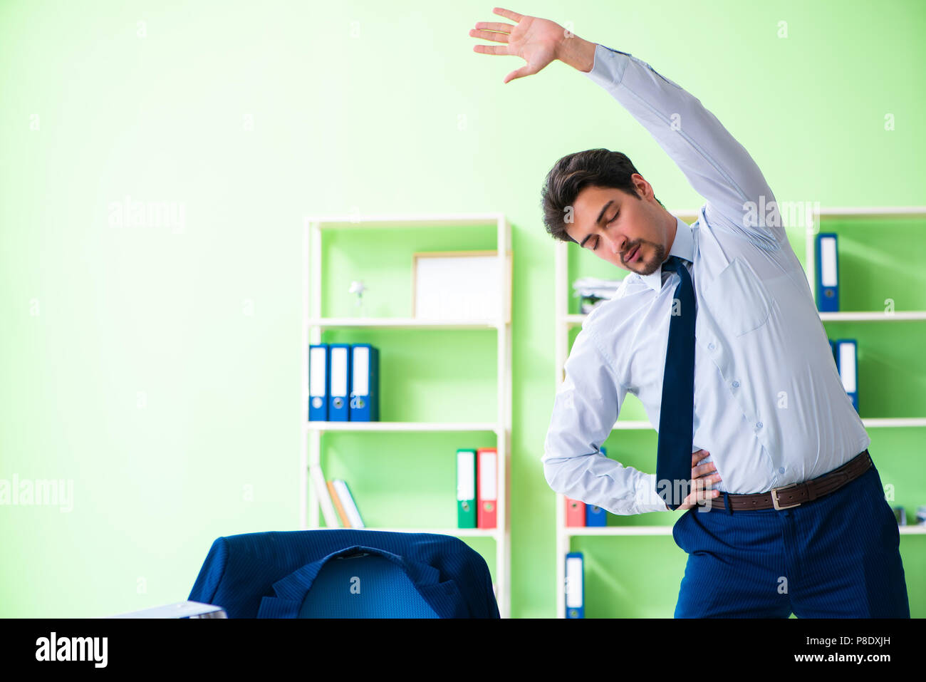 Employee doing exercises during break at work Stock Photo - Alamy
