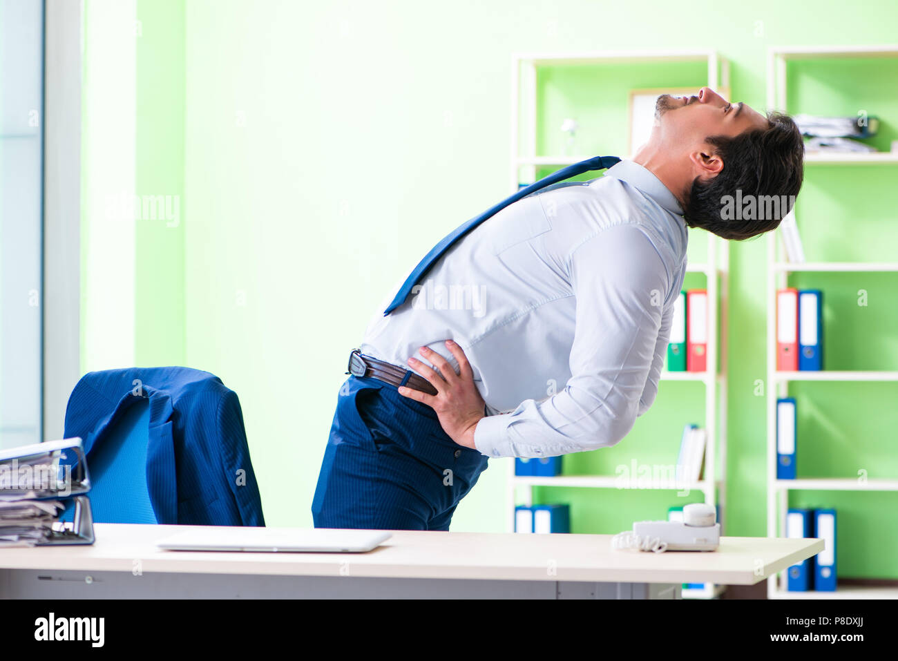 Employee doing exercises during break at work Stock Photo - Alamy