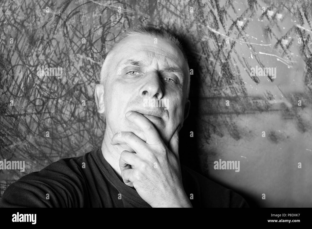 Studio portrait of a thoughtful man, in black and whie Stock Photo - Alamy