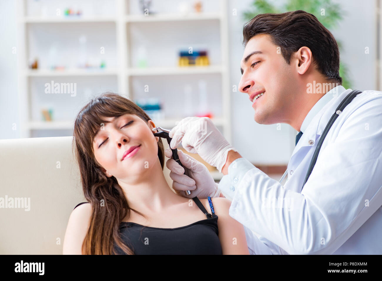 Doctor checking patients ear during medical examination Stock Photo - Alamy