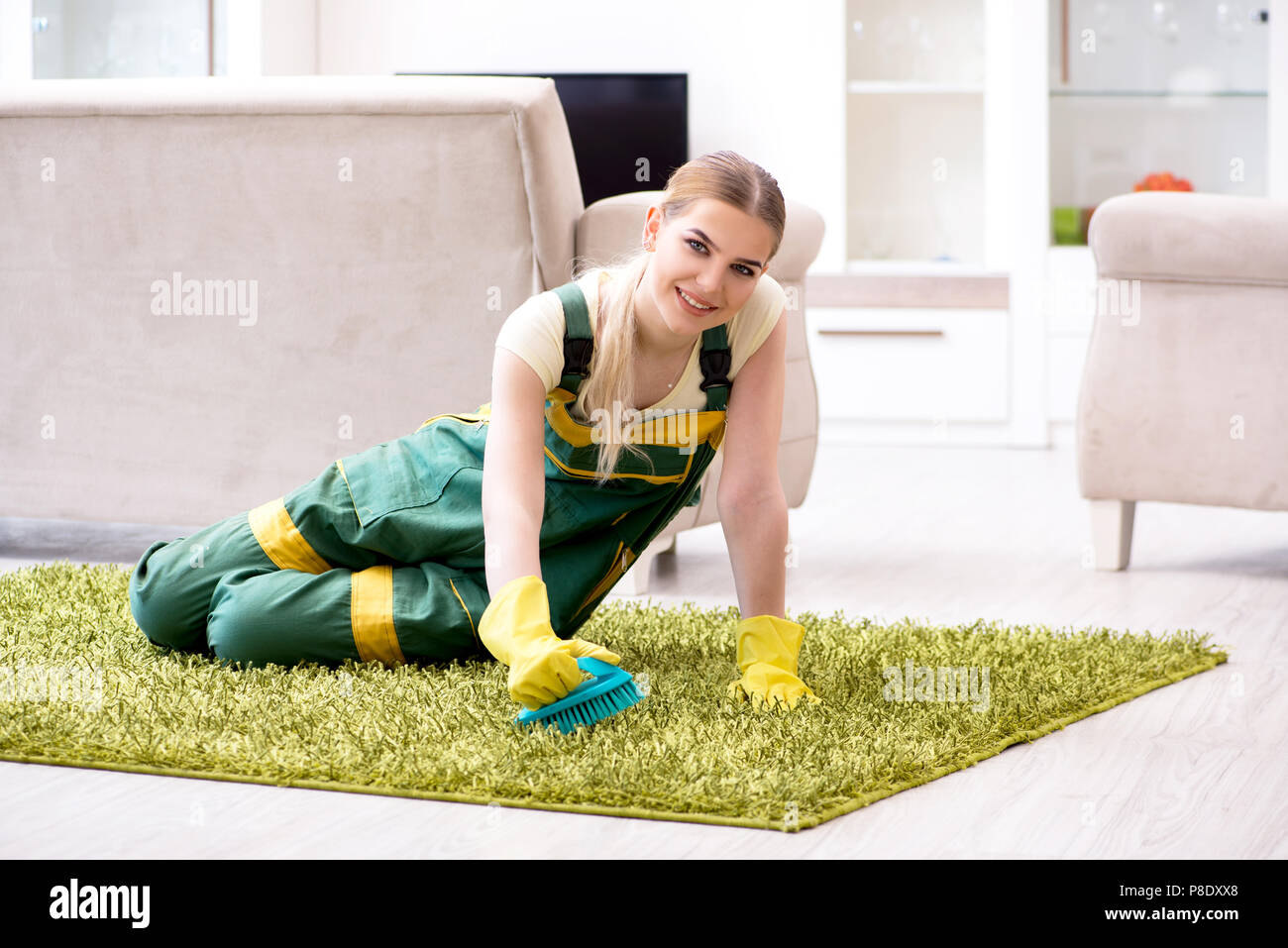 Professional female cleaner cleaning carpet Stock Photo - Alamy