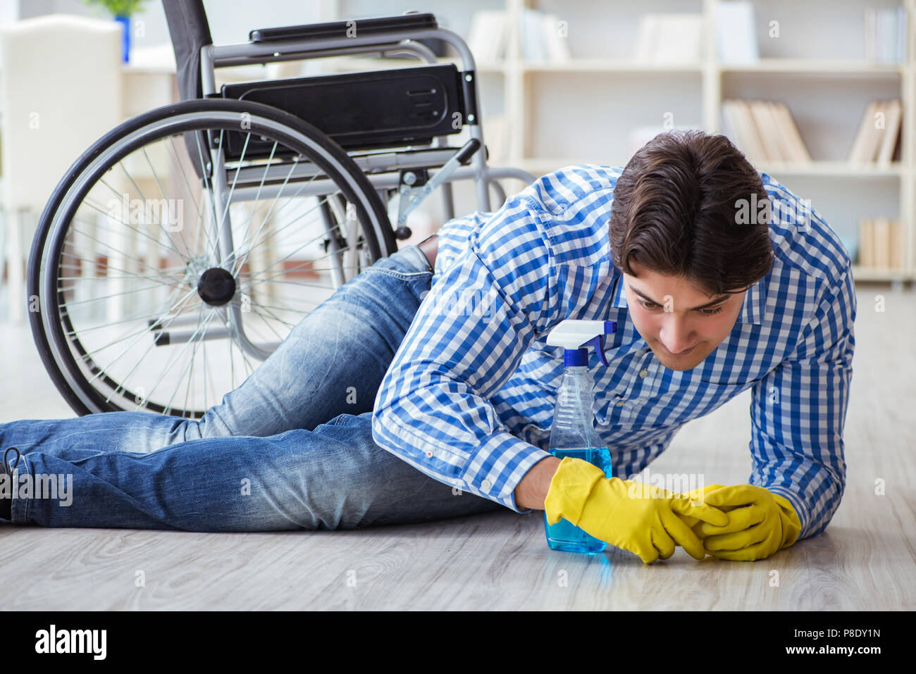 Disabled man on wheelchair cleaning home Stock Photo - Alamy