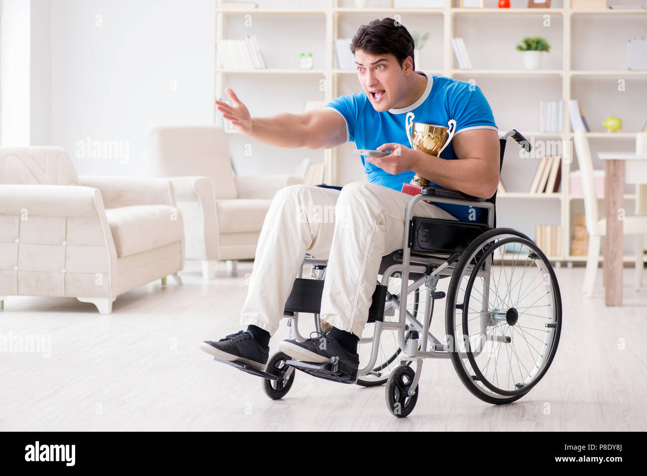 Disabled man watching sports on tv Stock Photo - Alamy