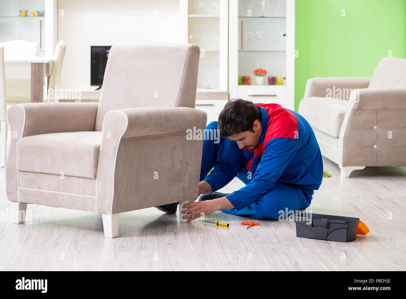 Repair contractor repairing broken furniture at home Stock Photo - Alamy