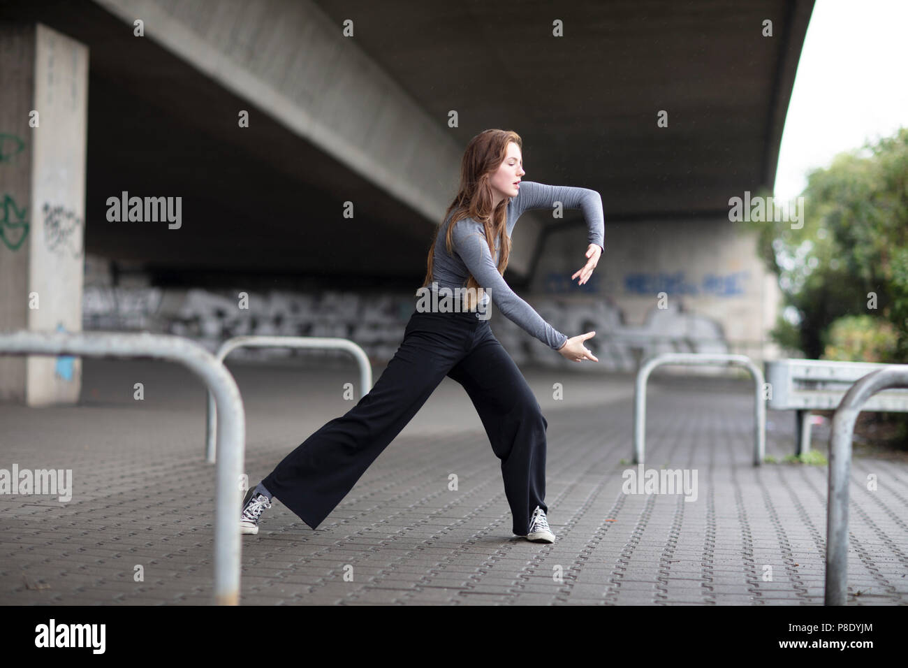 Female street dancer performing on a sidewalk. Full length Stock Photo ...
