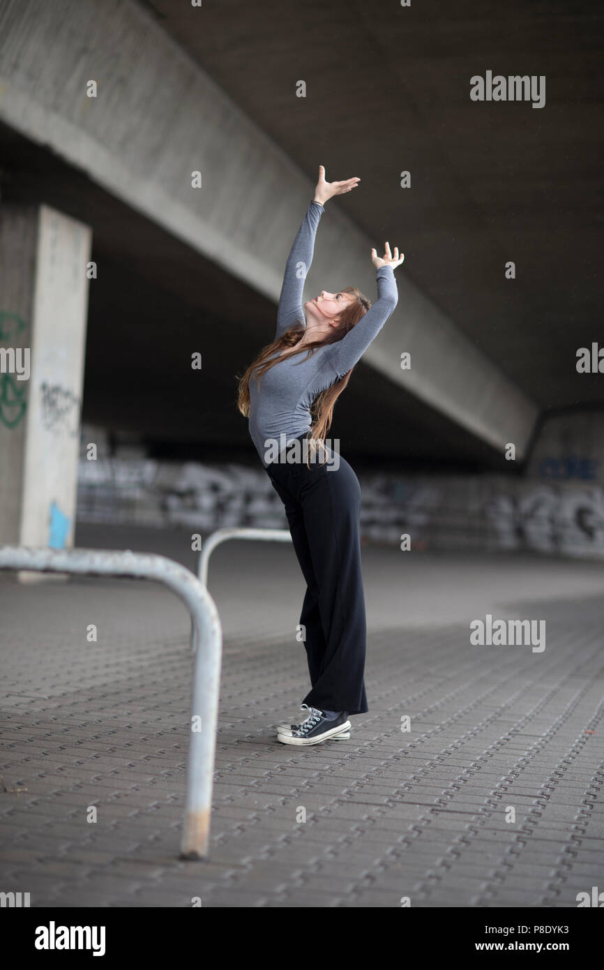Female street dancer performing on a sidewalk. Full length Stock Photo ...