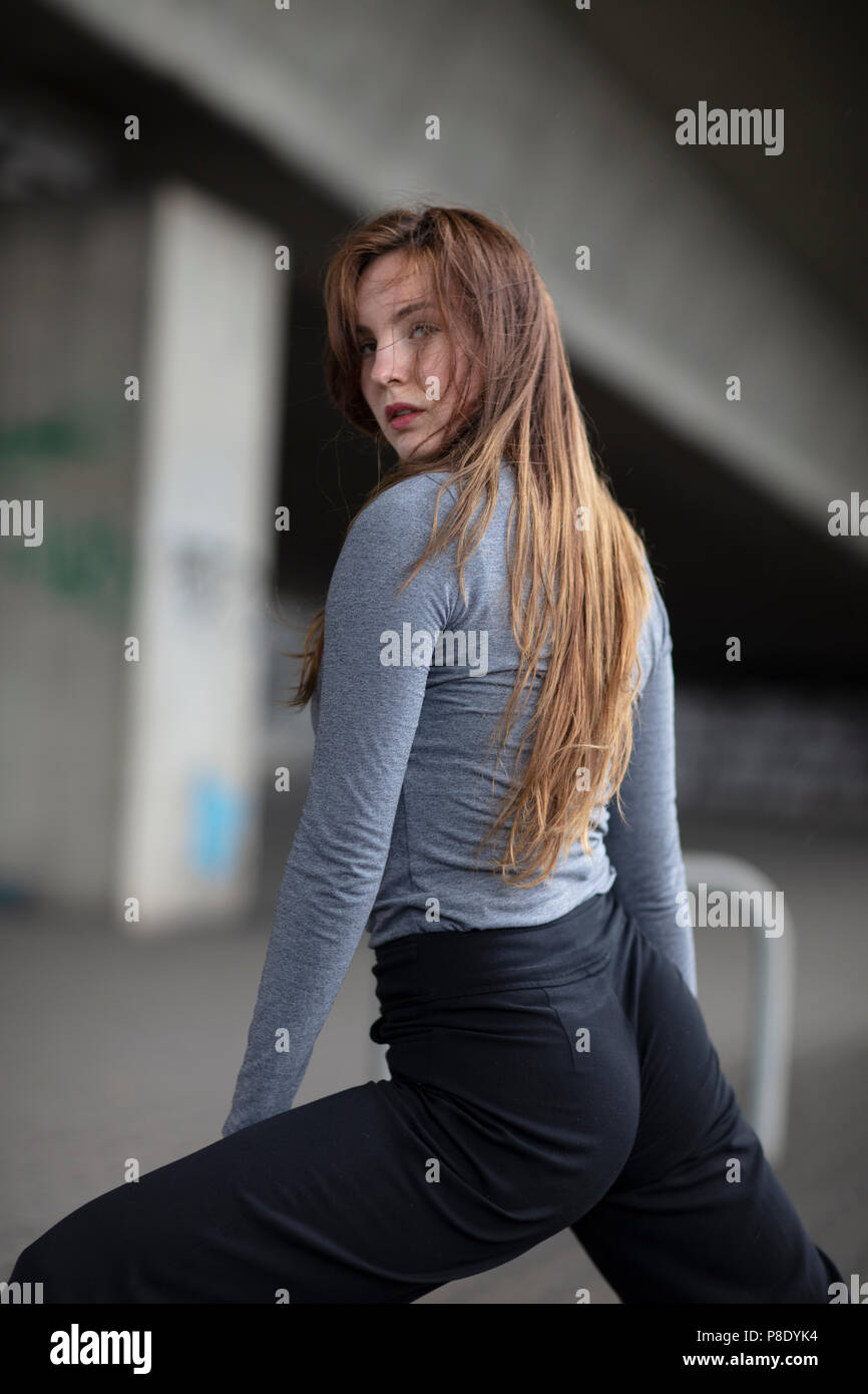 Female dancer looking at the camera seductively while standing in a ...