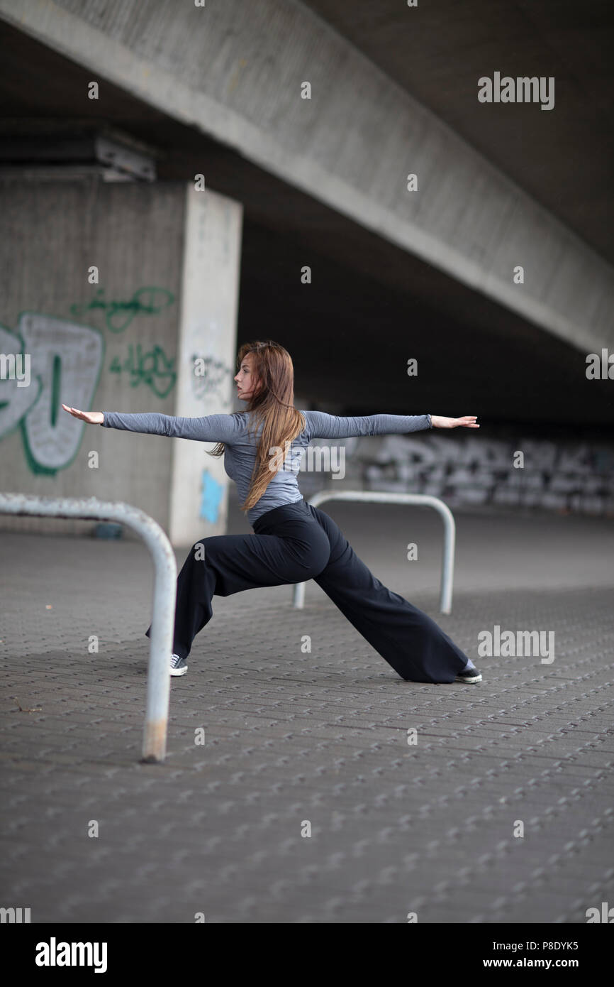 Female street dancer performing on a sidewalk. Full length Stock Photo ...