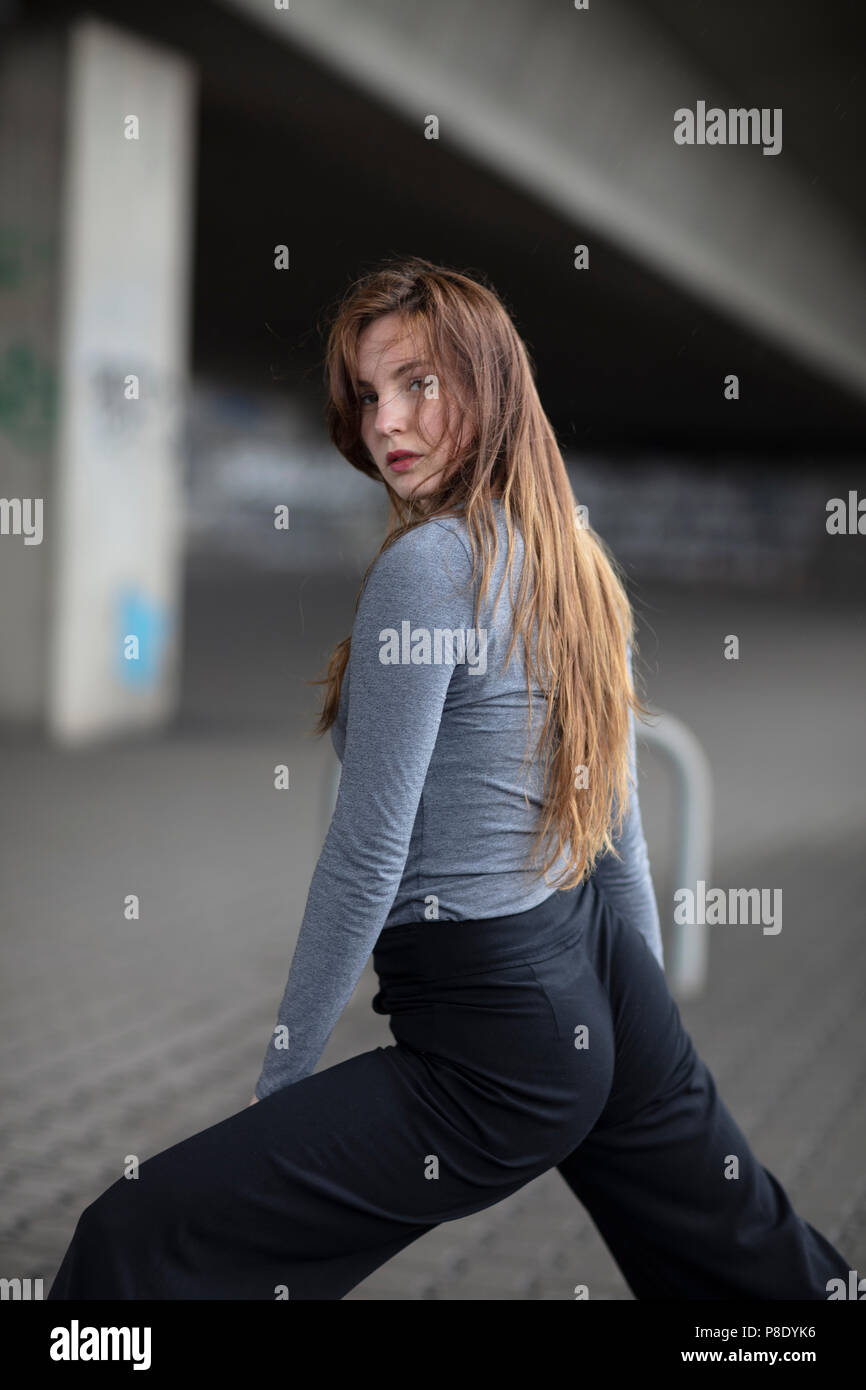 Female dancer looking at the camera seductively while standing in a ...