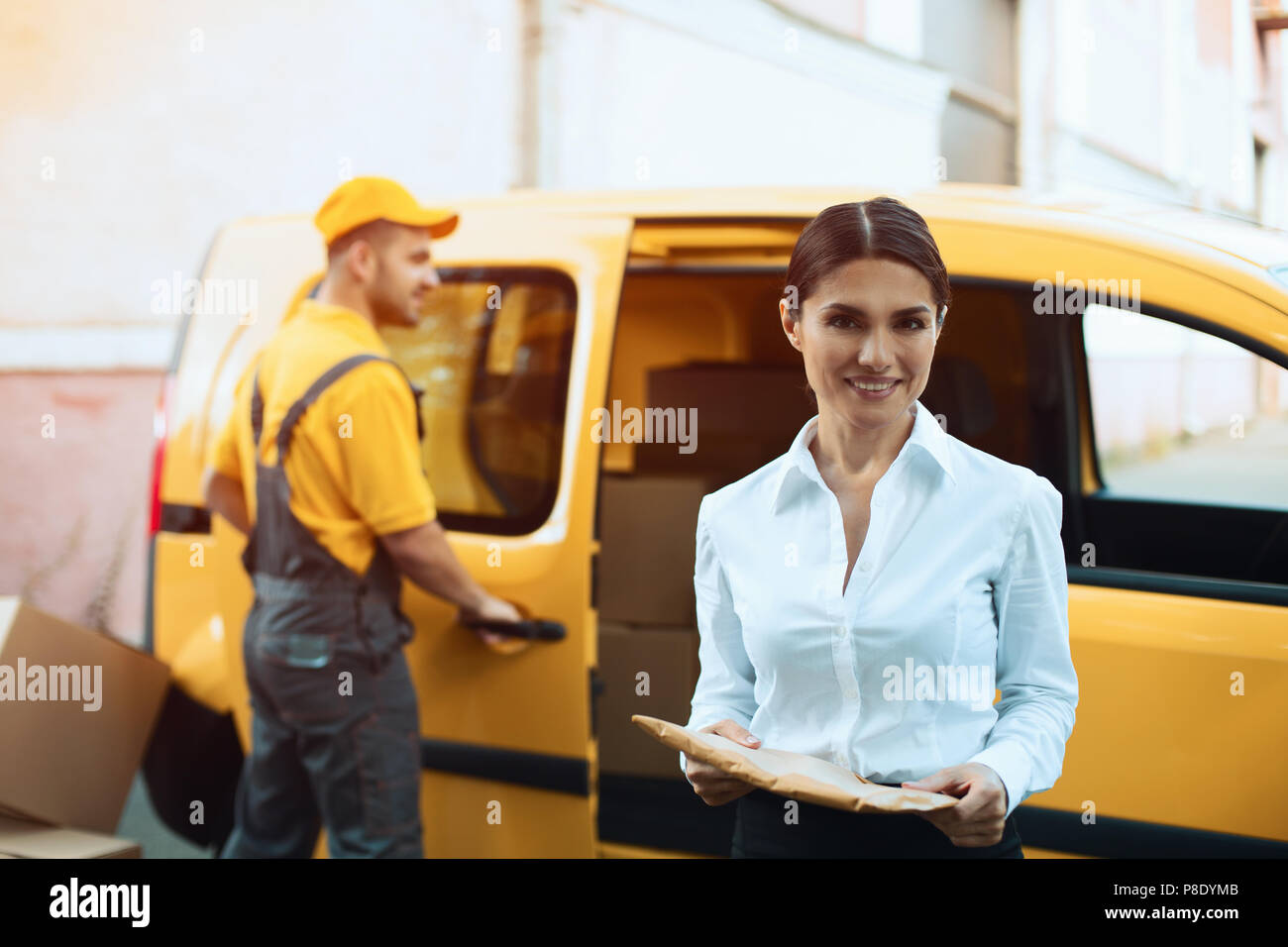 Delivery man closing van Stock Photo - Alamy