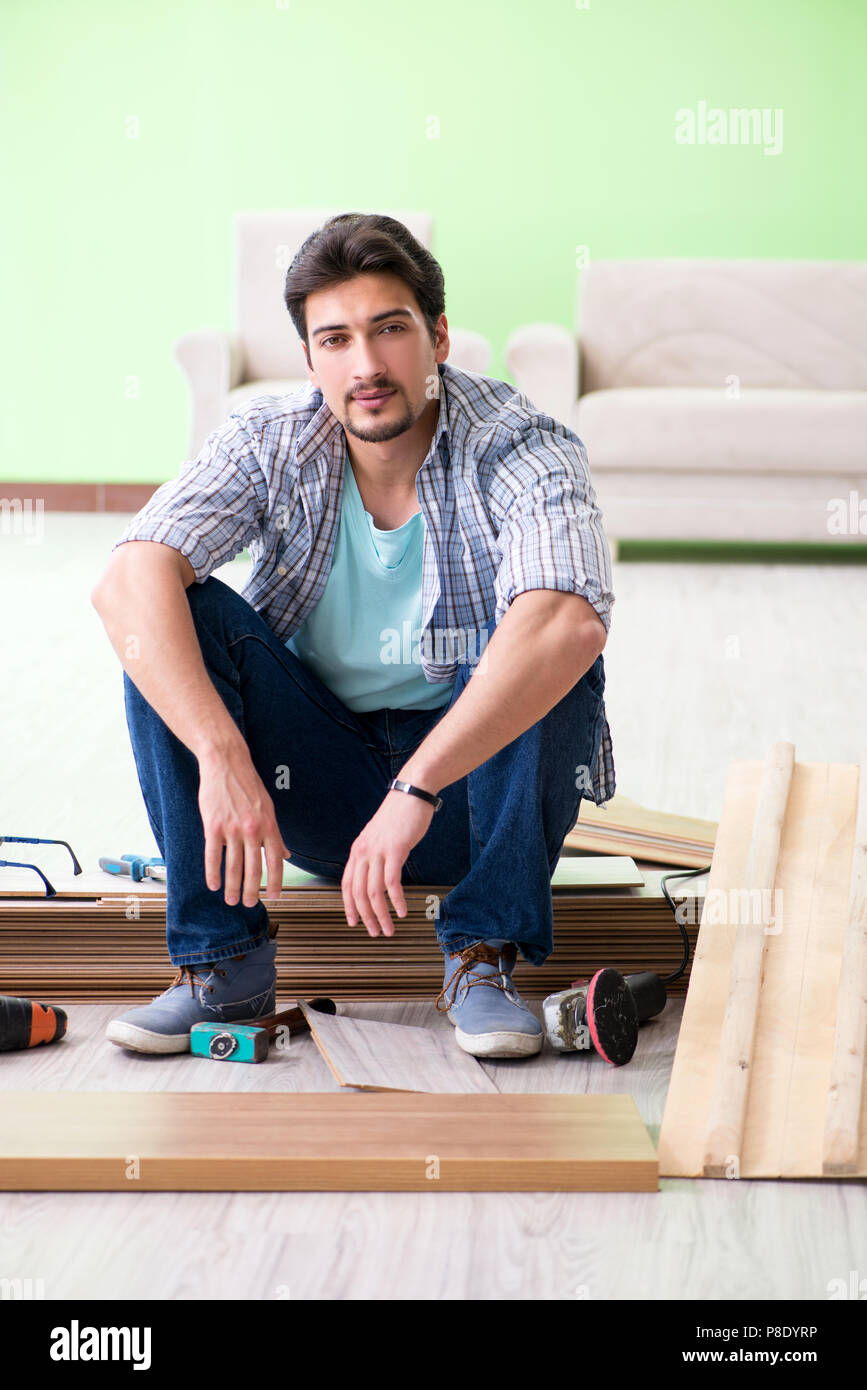 Man laying flooring at home Stock Photo - Alamy