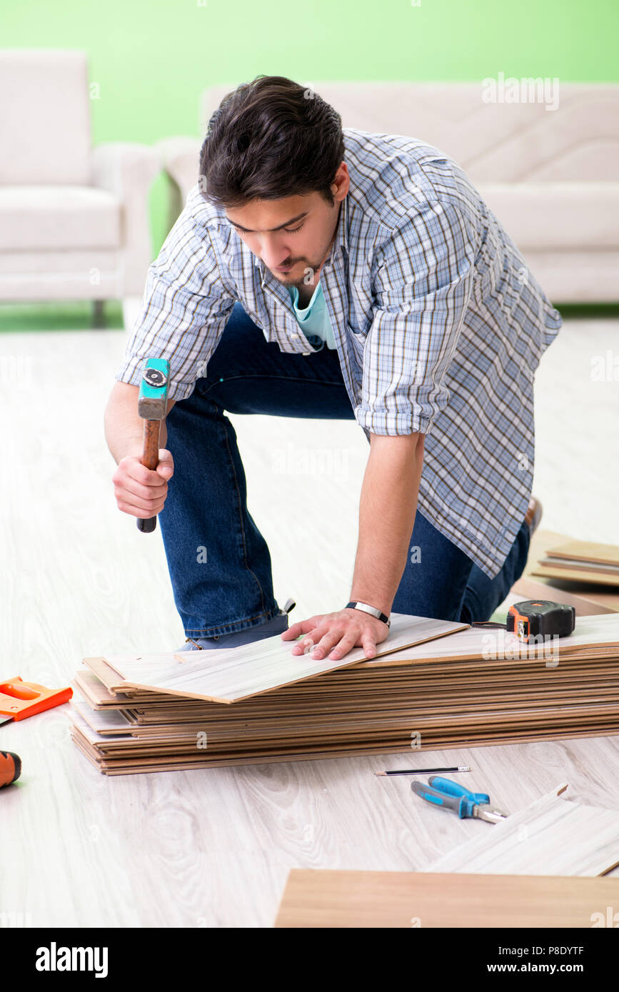 Man laying flooring at home Stock Photo - Alamy