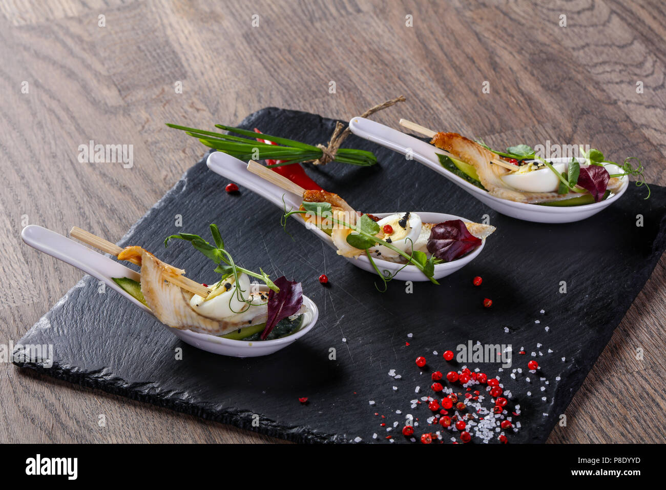 Snack with eel and quail egg Stock Photo - Alamy