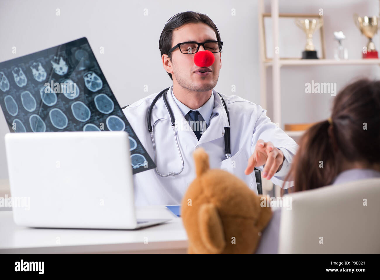 Funny pediatrician with little girl at regular check-up Stock Photo - Alamy