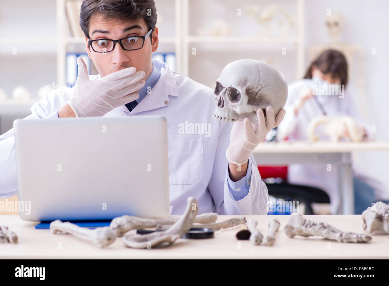 Professor studying human skeleton in lab Stock Photo - Alamy