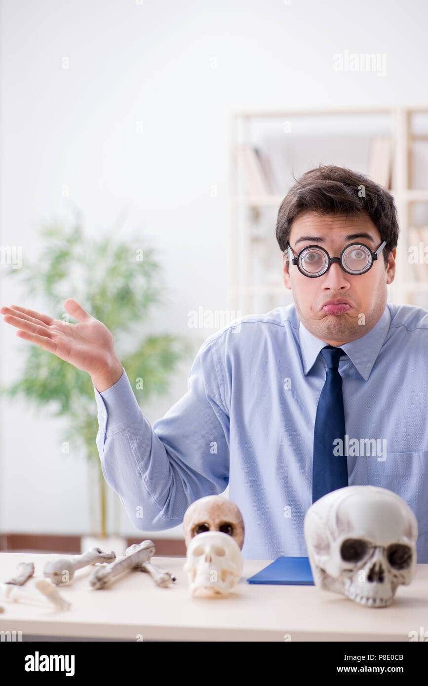 Funny crazy professor studying human skeleton Stock Photo - Alamy