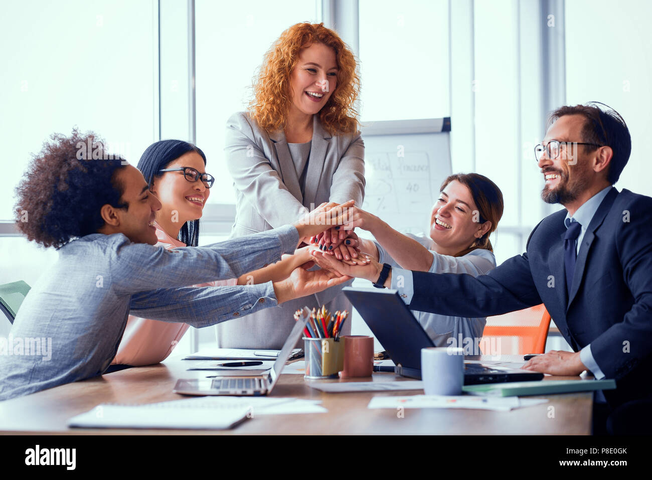 Business solution ready. Business team holding hands together ...