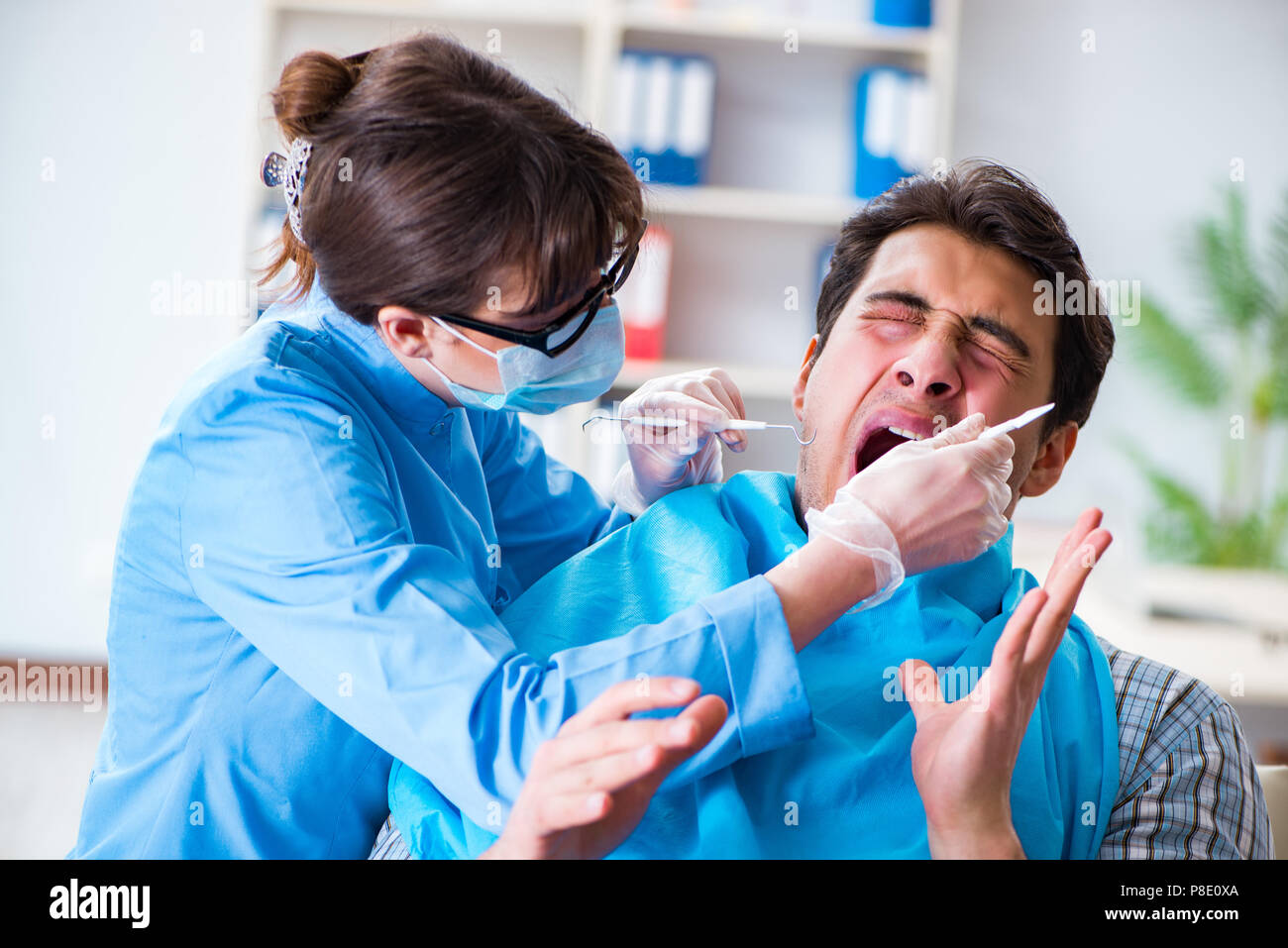 Patient afraid of dentist during doctor visit Stock Photo - Alamy