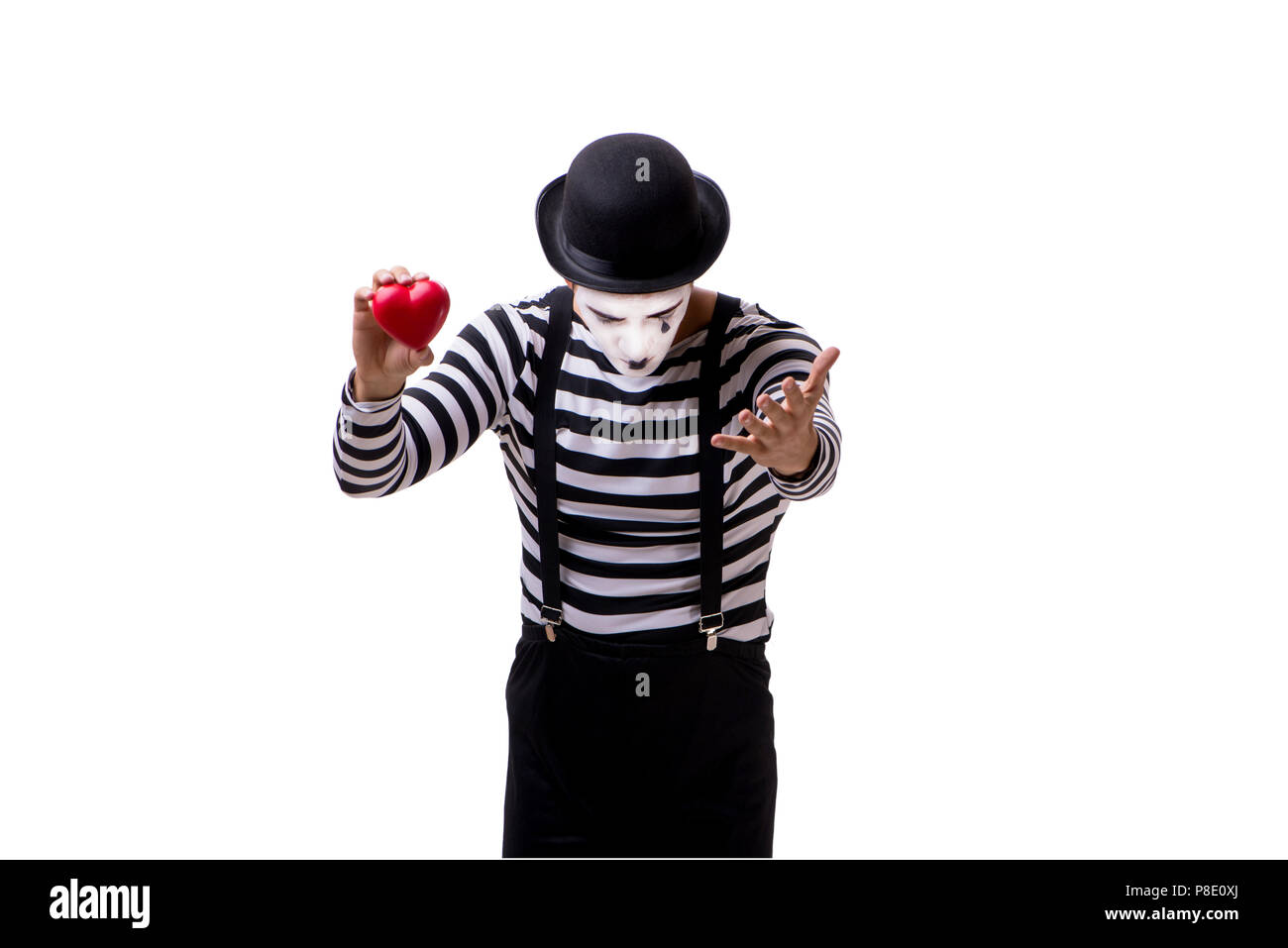 Mime holding red heart isolated on white background Stock Photo - Alamy