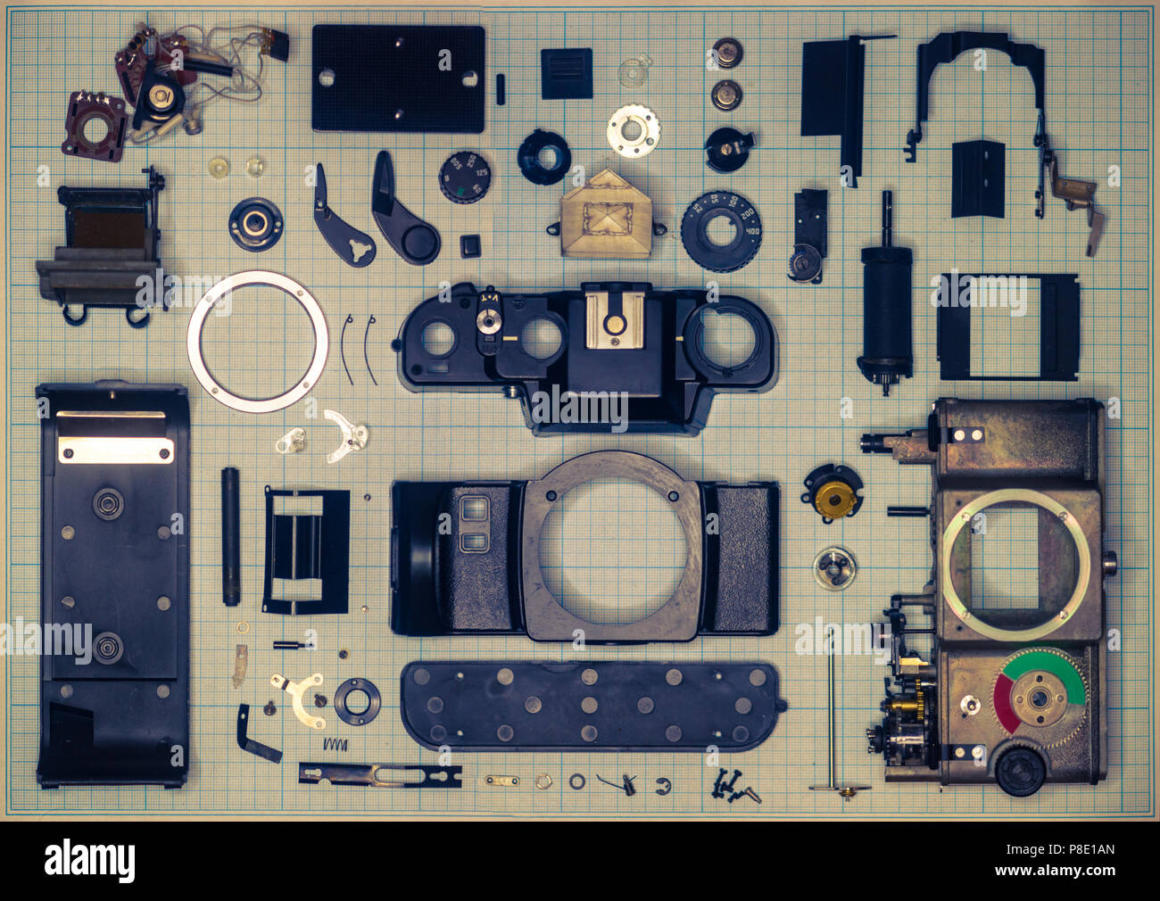 parts are completely disassembled old retro film SLR camera on graph ...