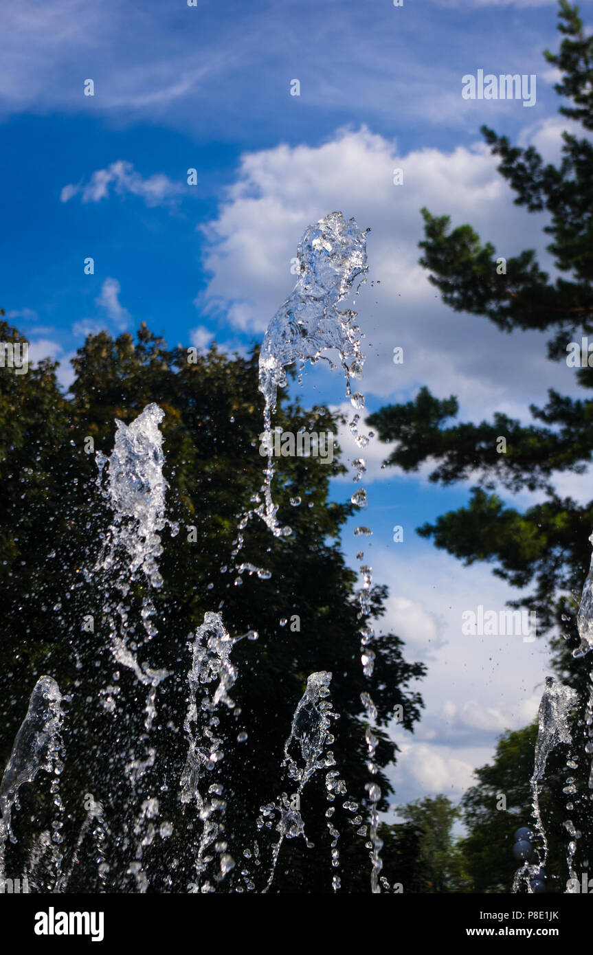 Fountain in city park on hot summer day, beautiful bright streams of ...