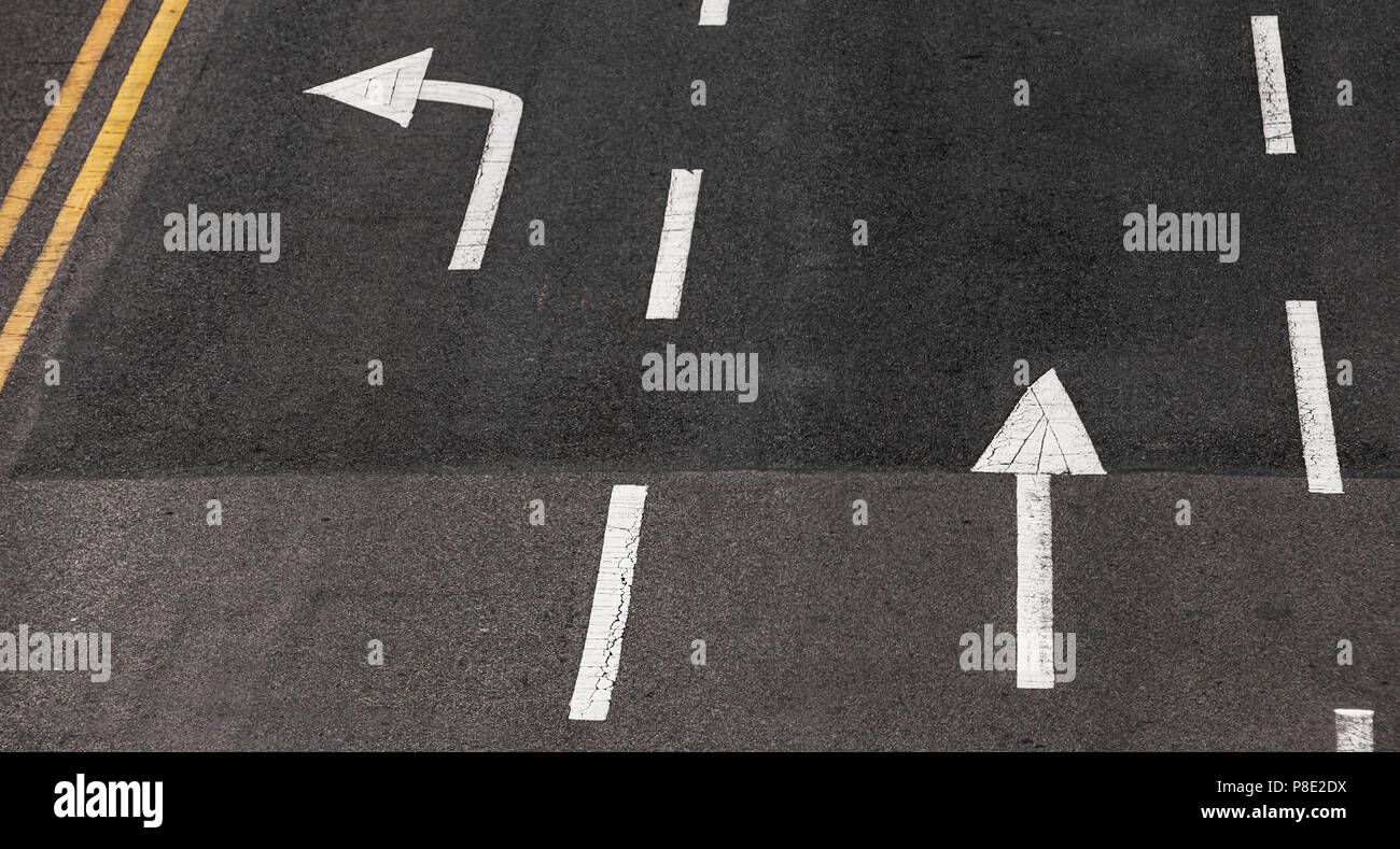 Driving directions by lanes. White arrows and lines, road marking over ...