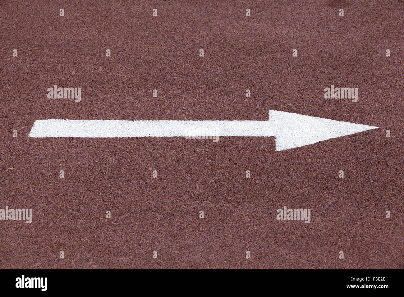 White arrow over red sport track, right move direction Stock Photo - Alamy