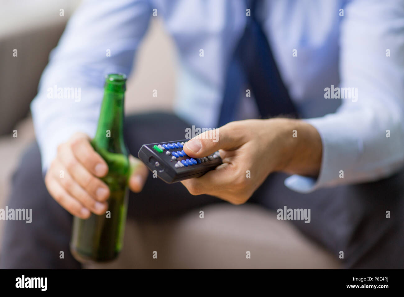 Businessman watching tv home hi-res stock photography and images - Alamy