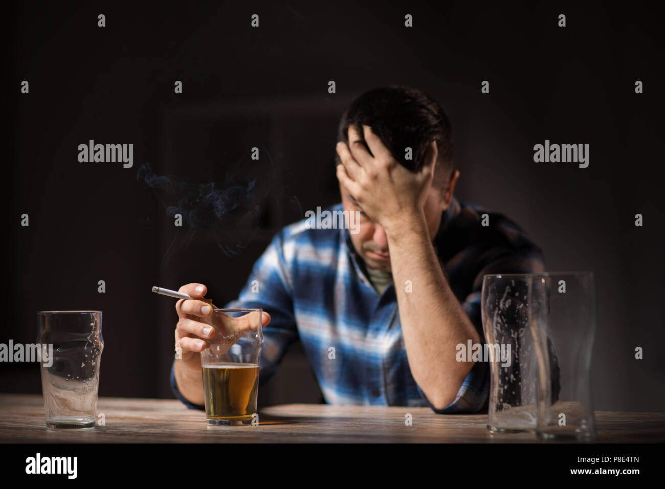 drunk man drinking alcohol and smoking cigarette Stock Photo - Alamy