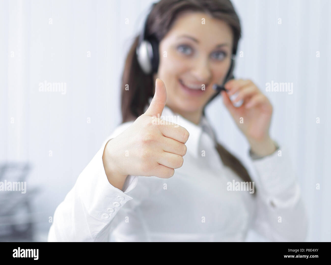 young employee call center showing thumb up Stock Photo - Alamy