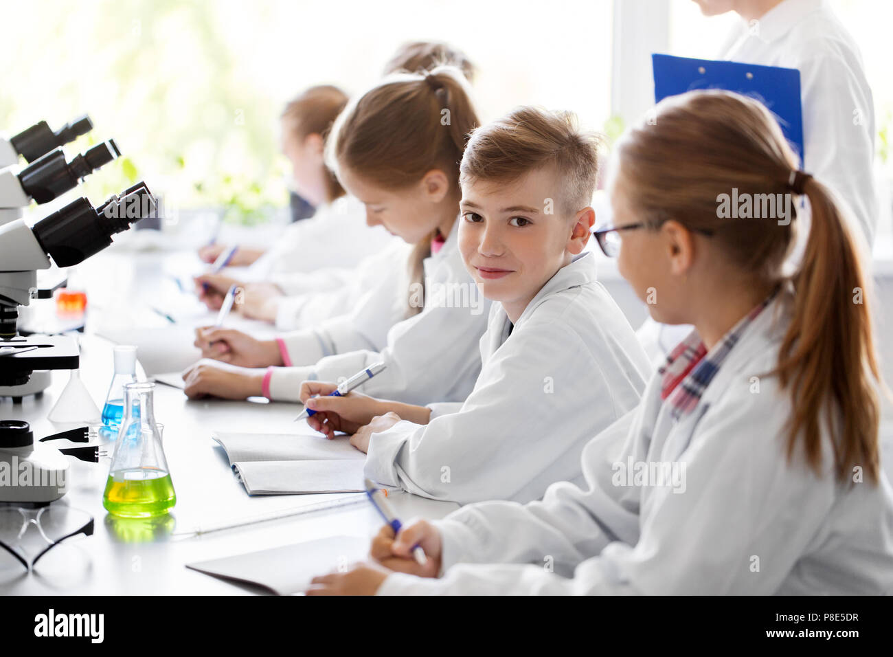kids studying chemistry at school laboratory Stock Photo - Alamy