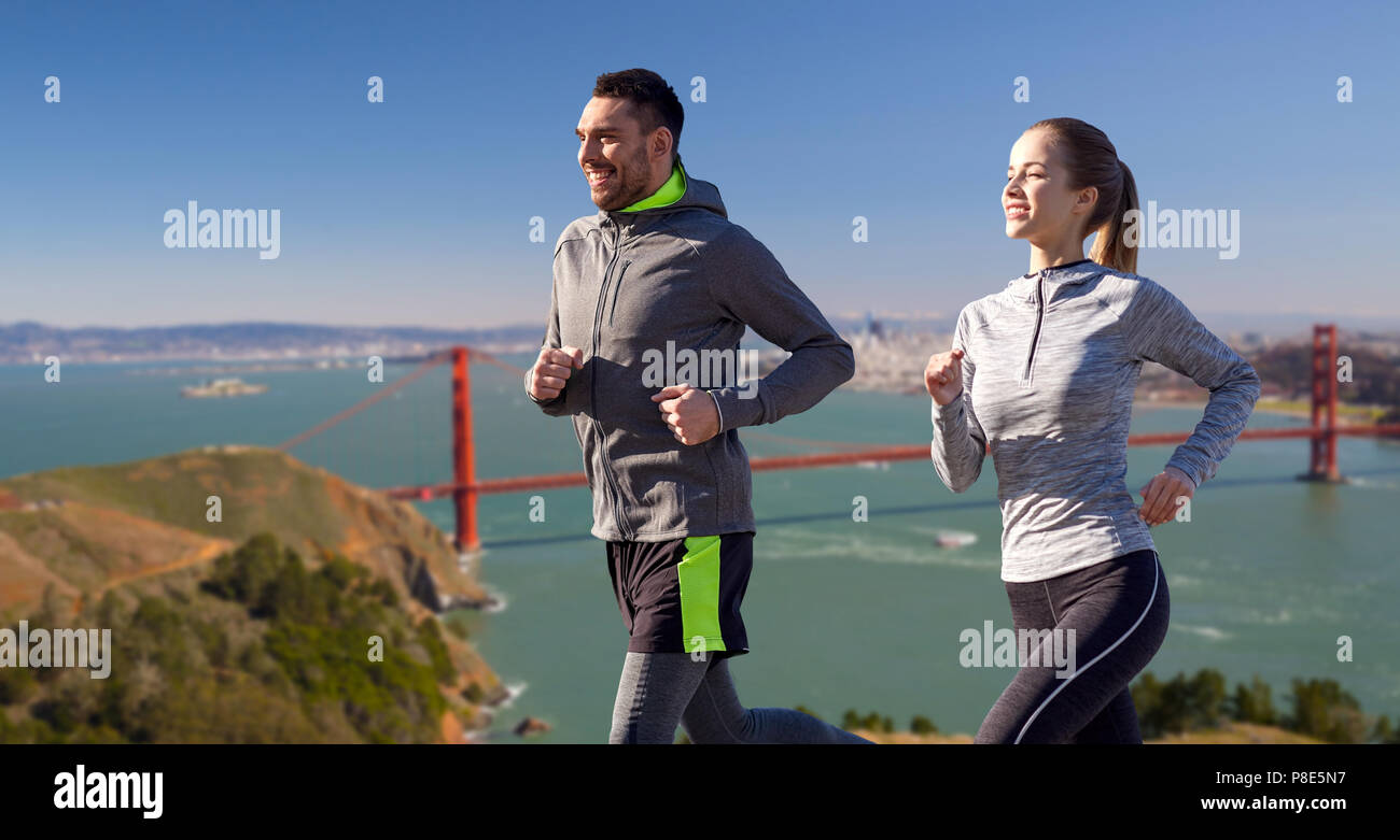 happy couple running over golden gate bridge Stock Photo - Alamy