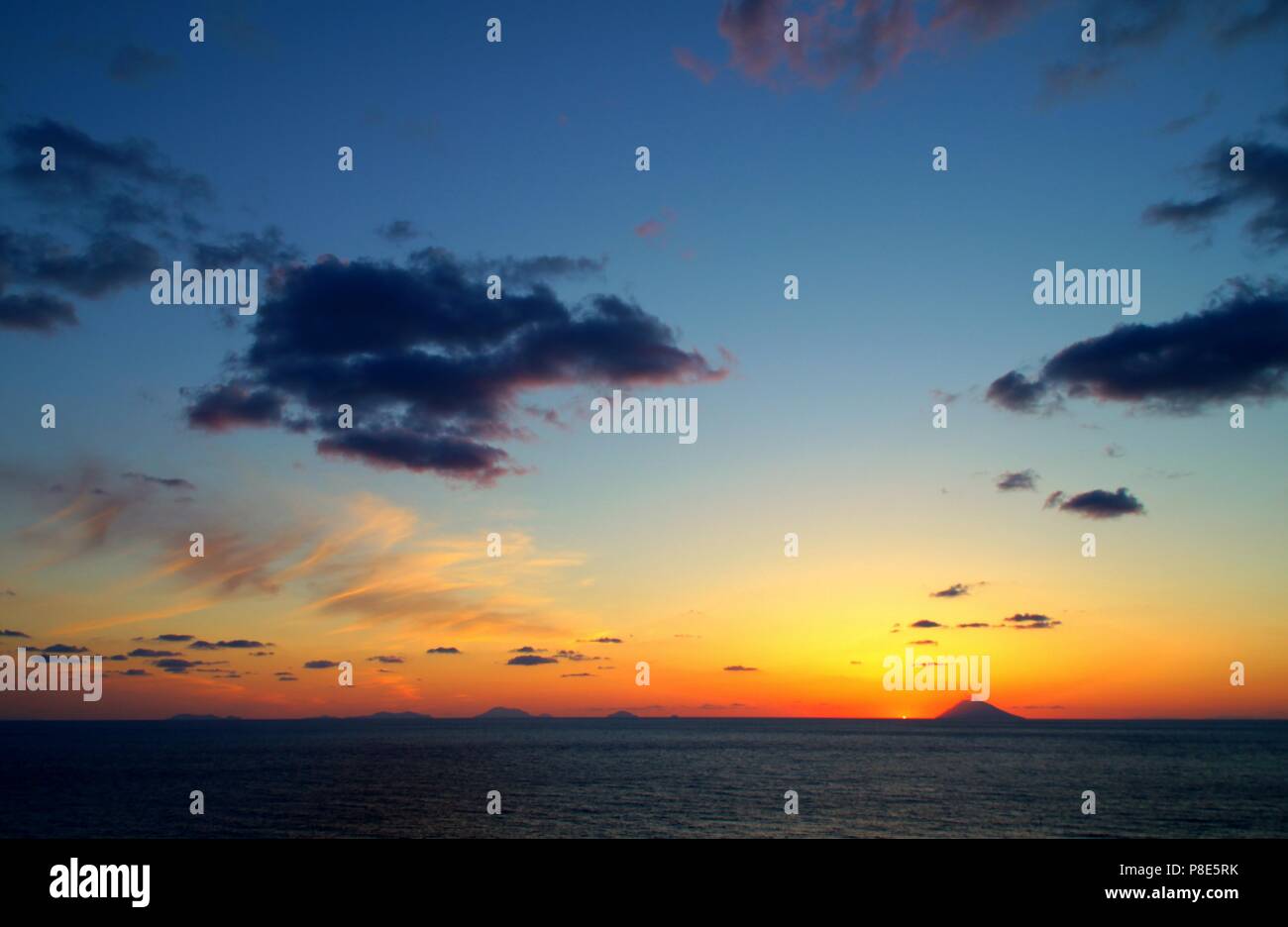 Sunset by The Tyrrhenian Sea. On the horizon Stromboli Volcano and ...