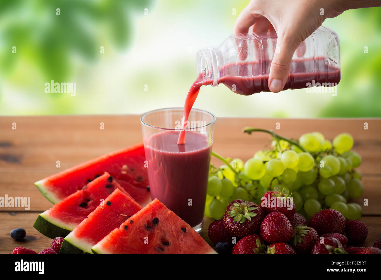 Woman pouring strawberry juice hi-res stock photography and images - Alamy