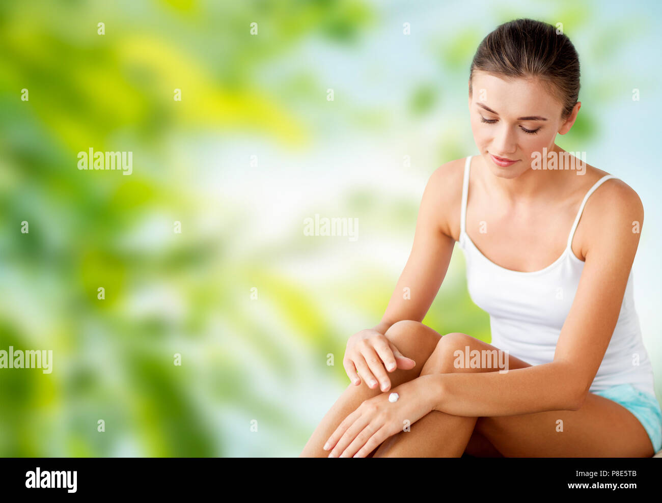 Beautiful young woman moisturizing hand hi-res stock photography and ...