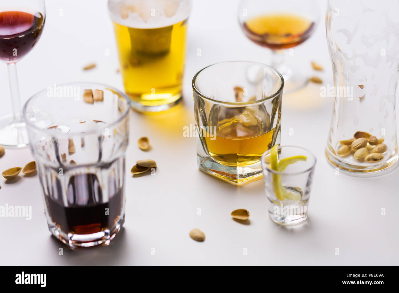 glasses of different alcohol drinks on messy table Stock Photo - Alamy