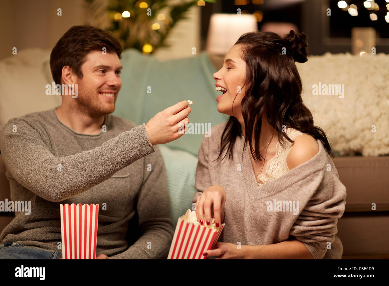 happy couple eating popcorn at home Stock Photo - Alamy