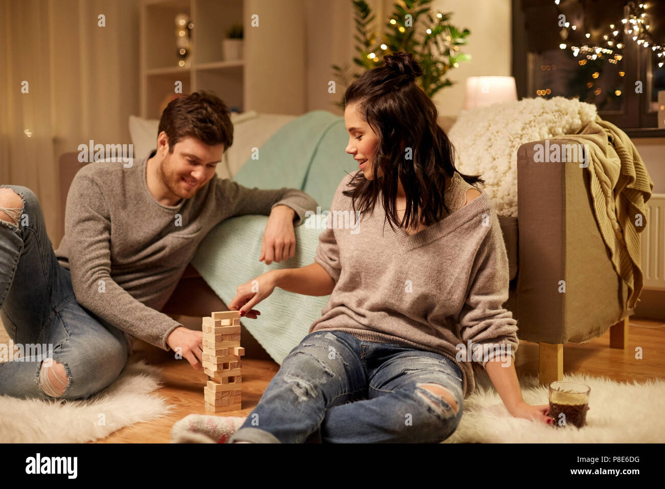 happy couple playing block-stacking game at home Stock Photo - Alamy