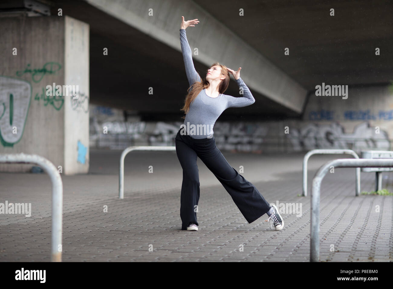 Female modern dancer performing on a city street. Full length Stock ...