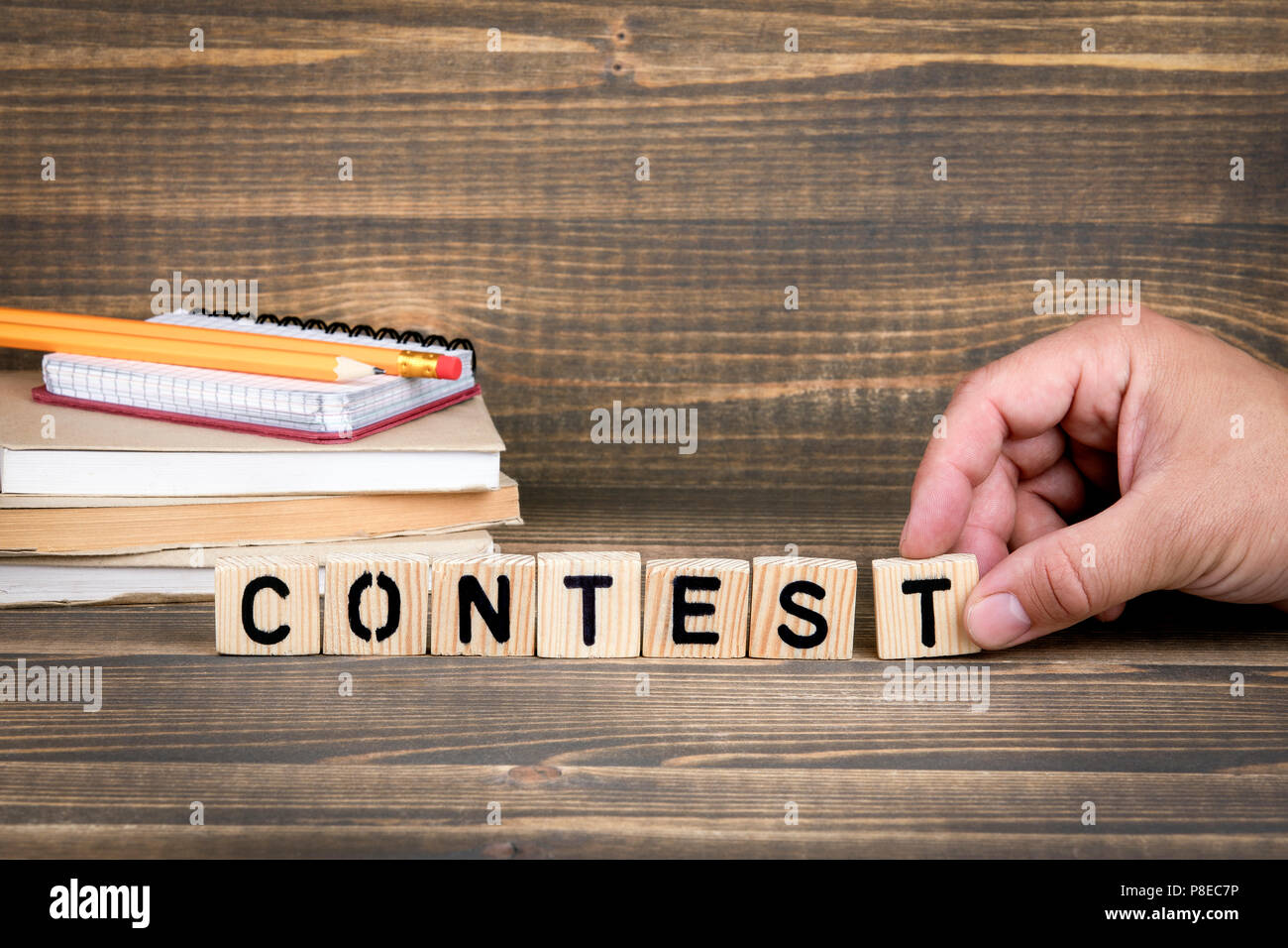 Contest. Wooden letters on the office desk Stock Photo - Alamy