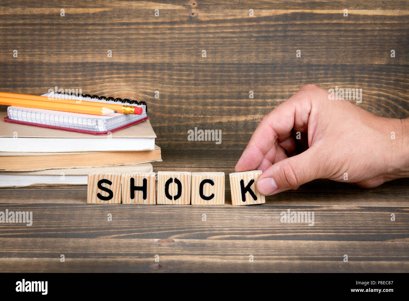 Shock. Wooden letters on the office desk Stock Photo - Alamy
