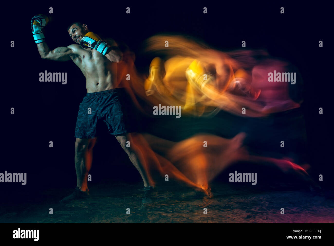 Male boxer boxing in a dark studio Stock Photo - Alamy