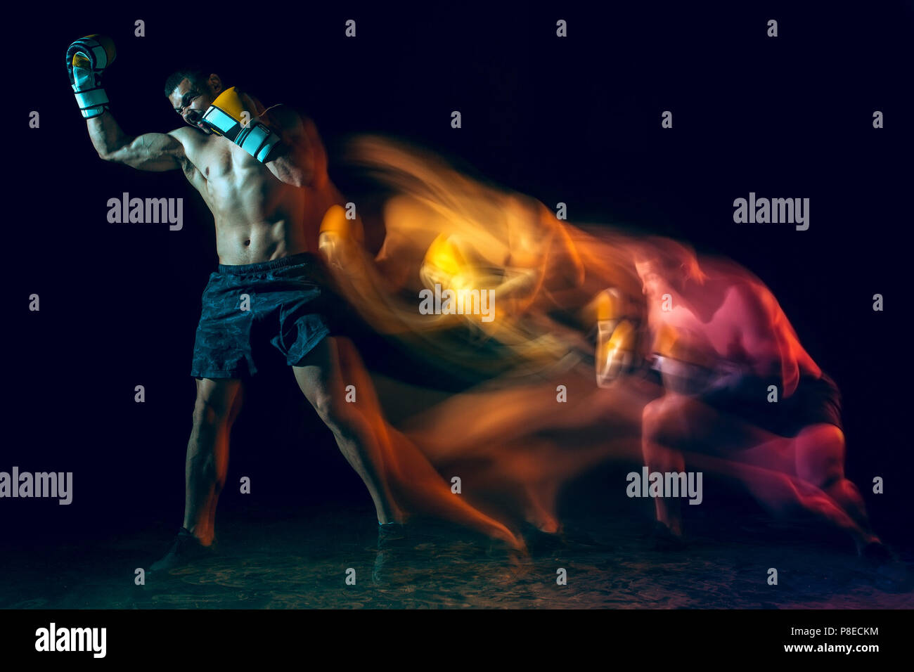 Male boxer boxing in a dark studio Stock Photo - Alamy