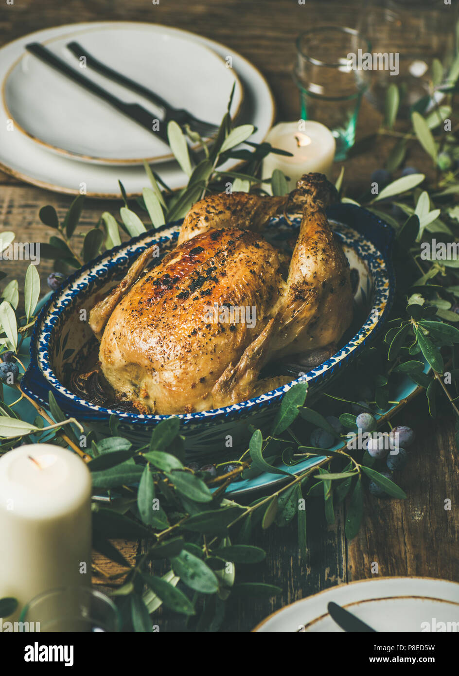 Whole roasted chicken decorated with olive tree branch Stock Photo - Alamy