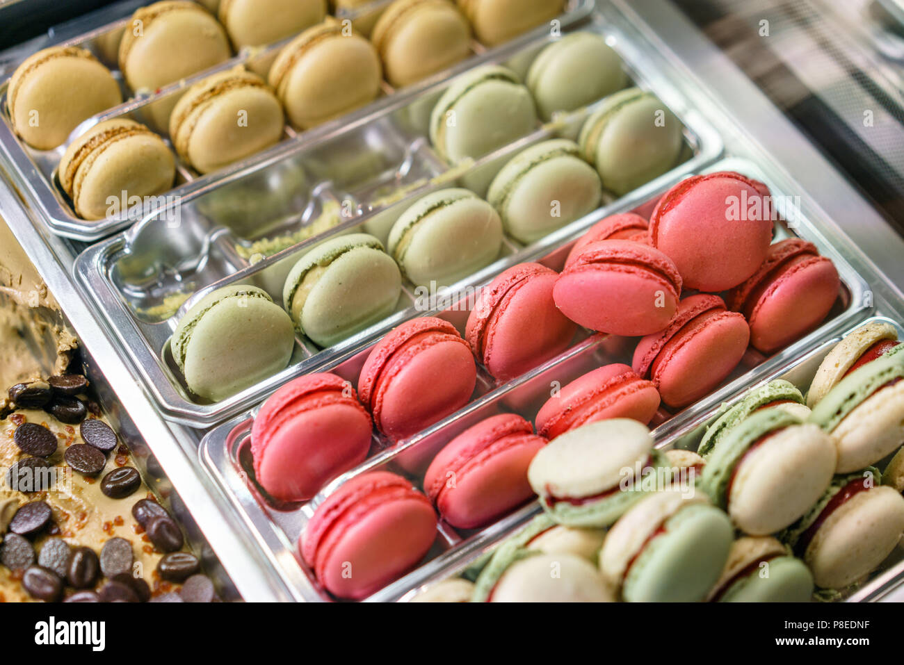 Assortment of colorful macaroons on cafe showcase. Variety of macaron ...